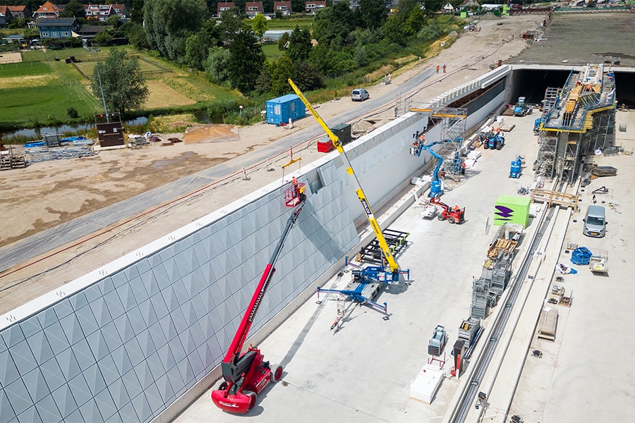Concrete structure 'encased' with aluminum pre-walls and slat cladding